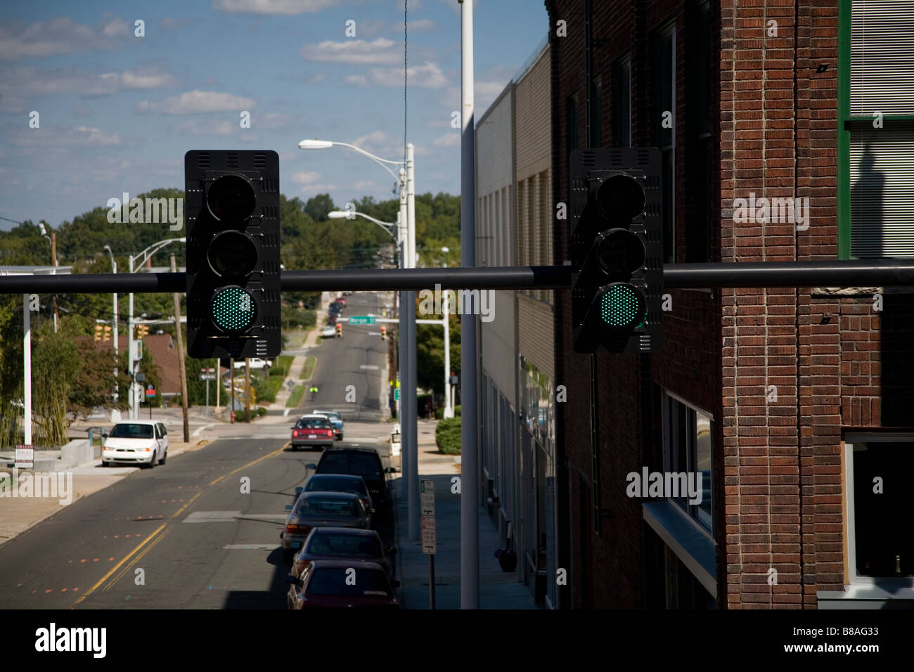 Photograph of a traffic signal which is green and the street below ...