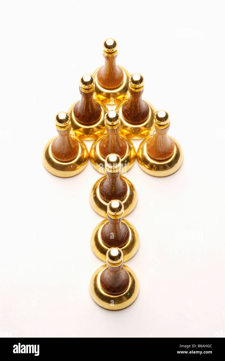 Chess pieces form arrow sign Stock Photo - Alamy