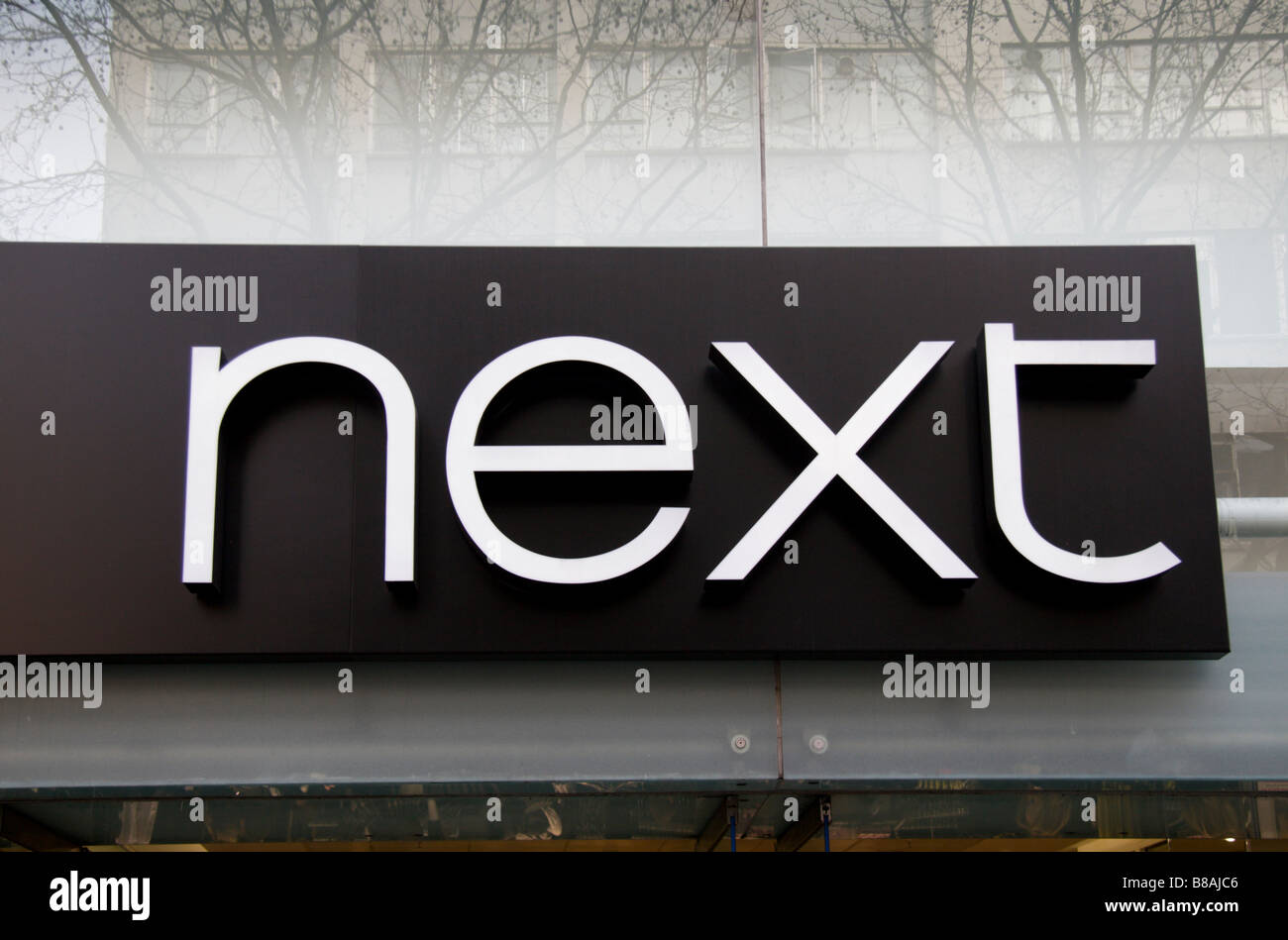 A sign above the door to the Next clothing shop, Oxford Street, London ...