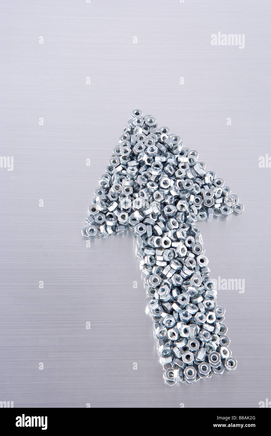 Metal nuts form arrow sign Stock Photo - Alamy