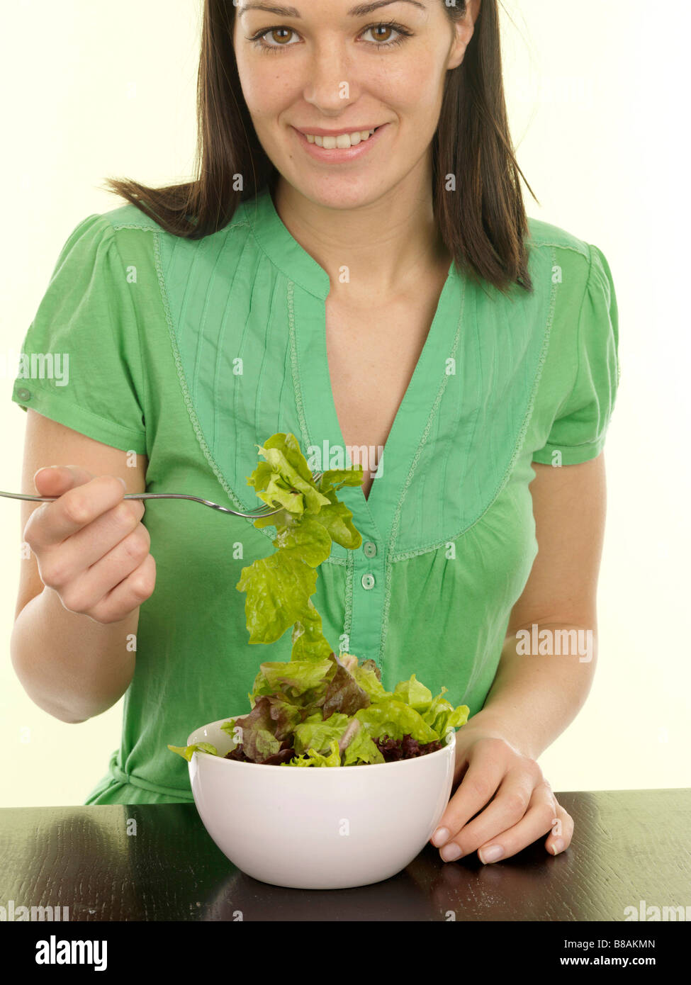 Young Woman Eating Freshly Prepared Healthy Green Salad With A Clipping ...