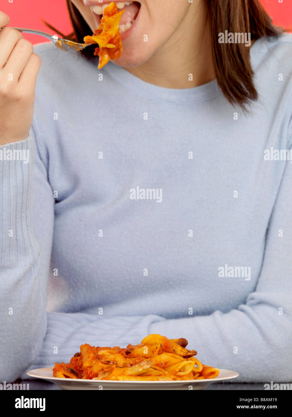 Young Woman Eating Pasta Bake Model Released Stock Photo - Alamy