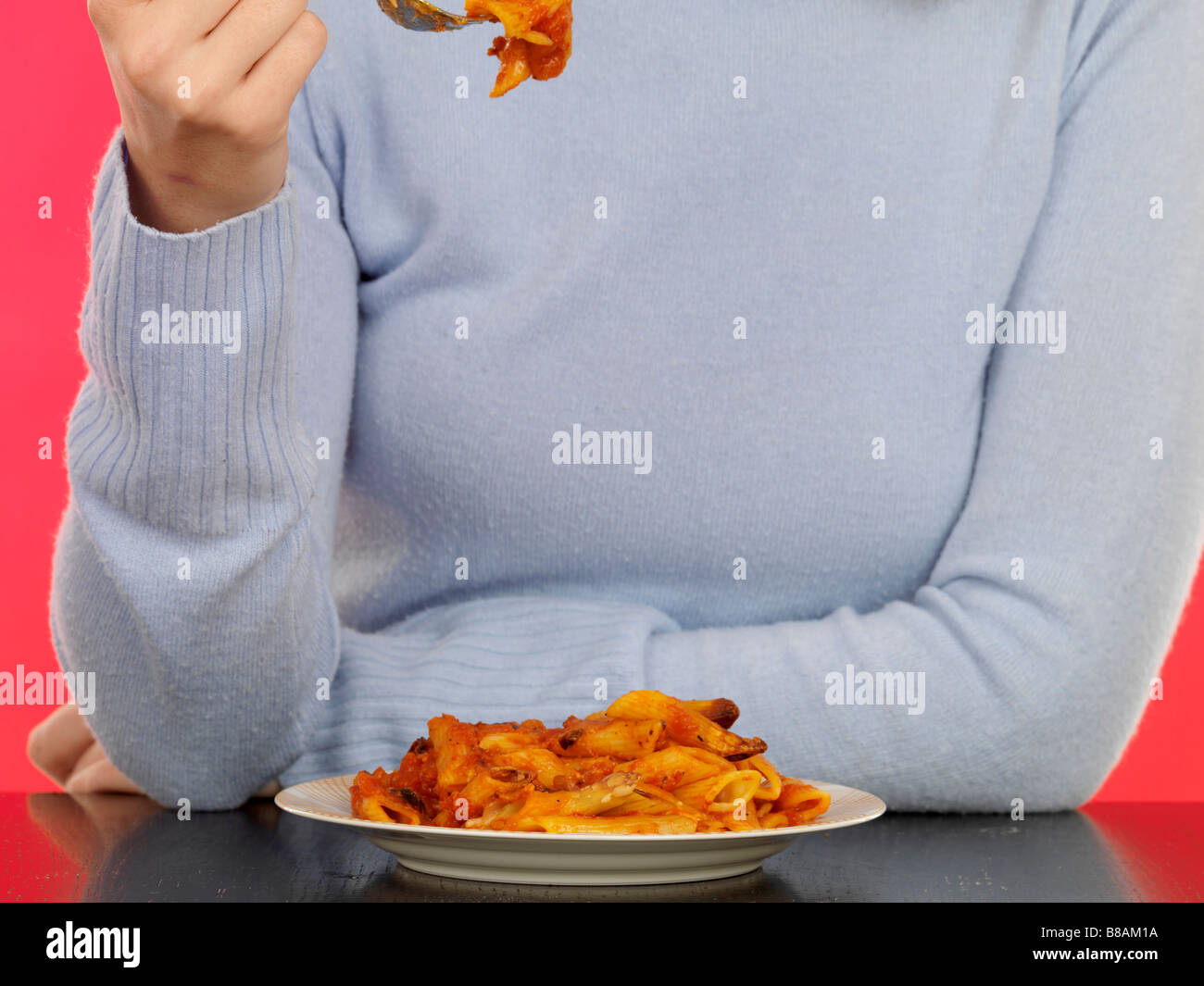 Young Woman Eating Pasta Bake Model Released Stock Photo - Alamy