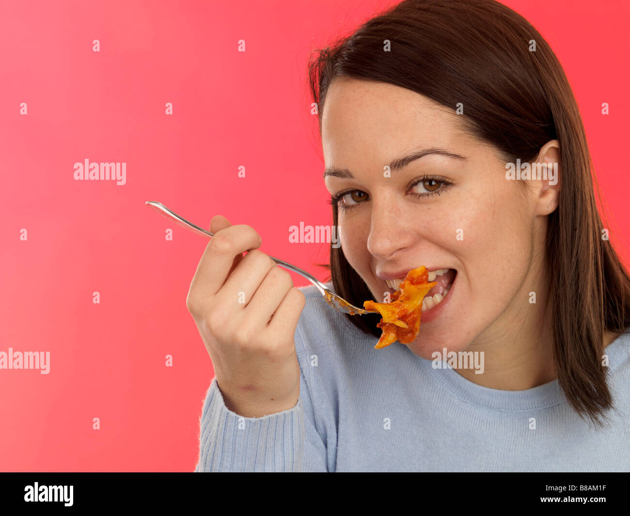 Young Woman Eating Pasta Bake Model Released Stock Photo - Alamy
