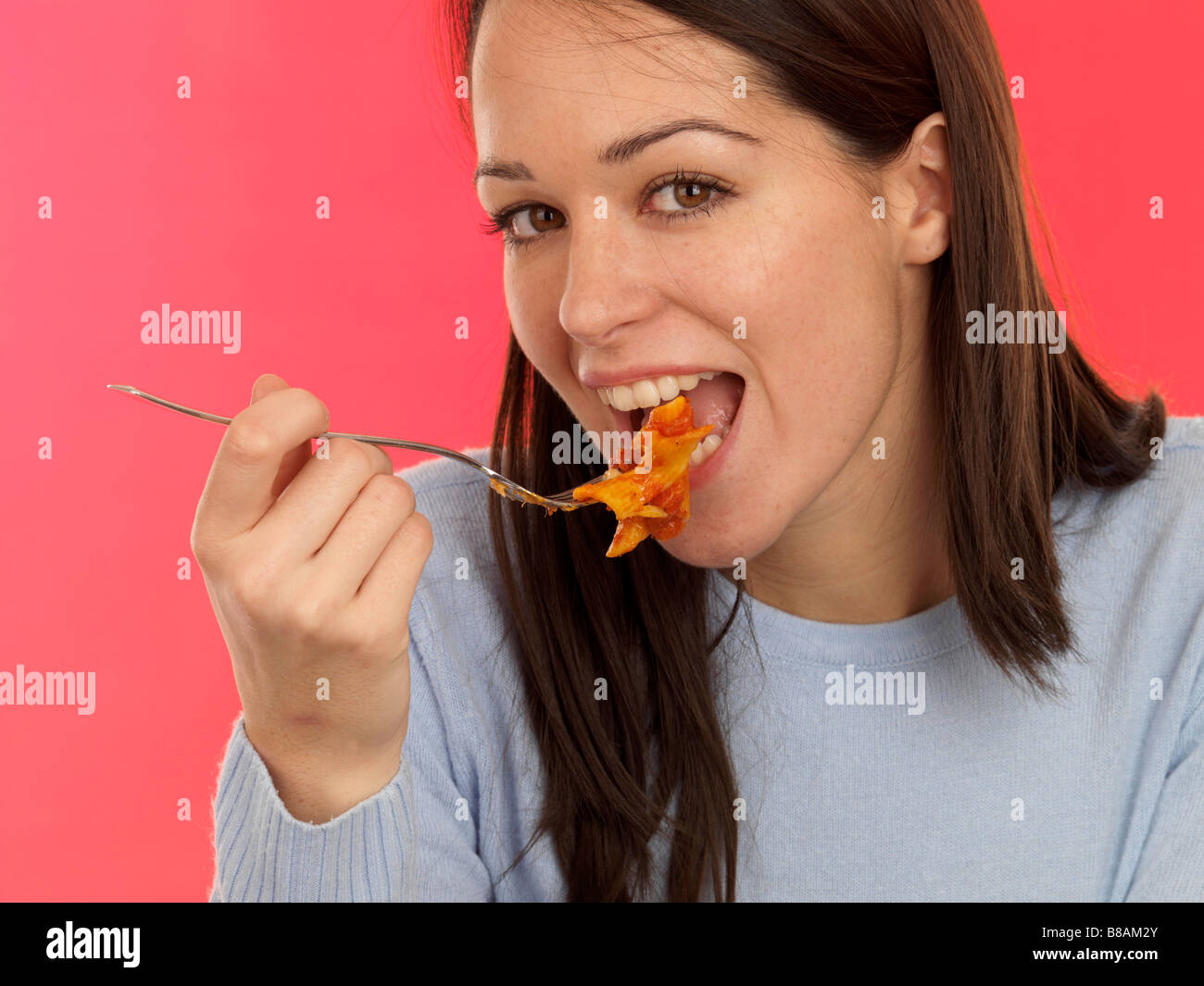 Young Woman Eating Pasta Bake Model Released Stock Photo - Alamy