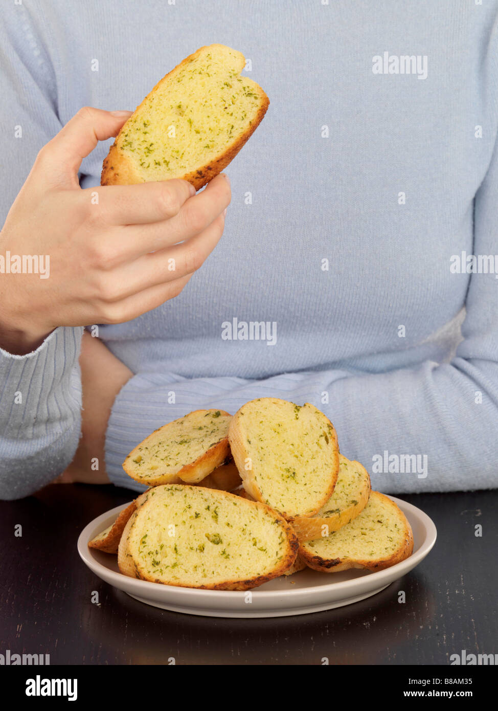 Young Woman Eating Garlic Bread Model Released Stock Photo - Alamy