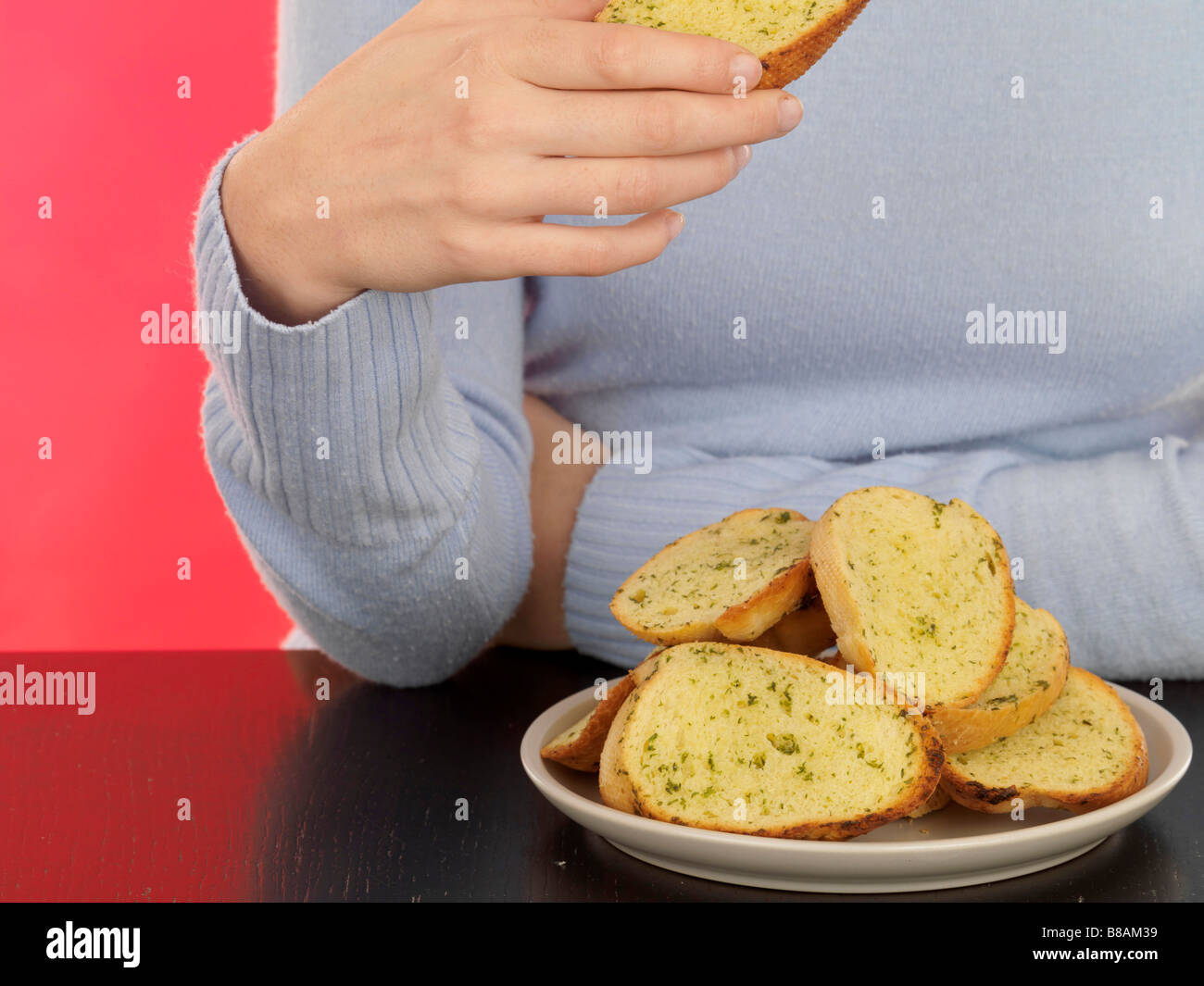 Young Woman Eating Garlic Bread Model Released Stock Photo - Alamy