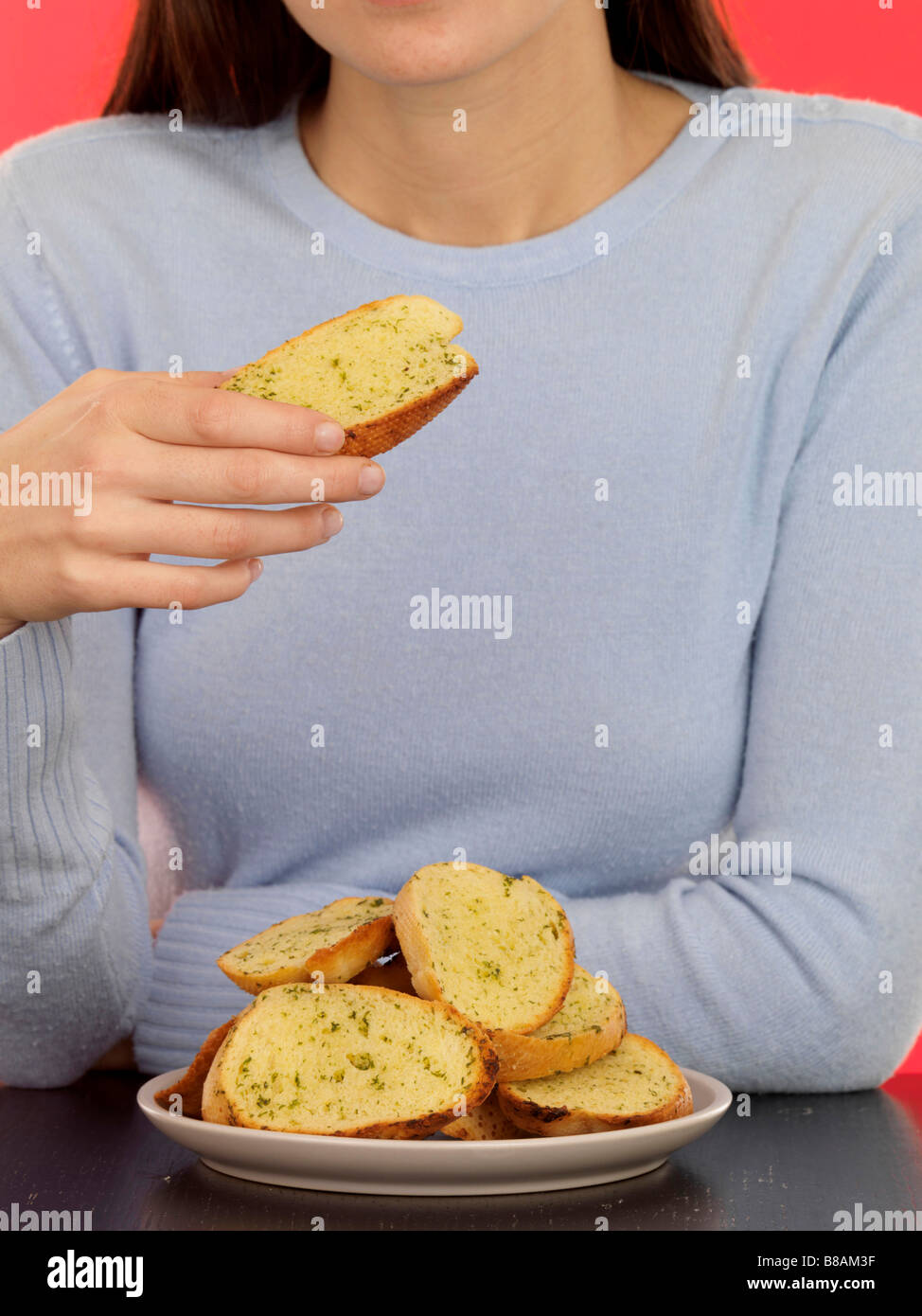 Young Woman Eating Garlic Bread Model Released Stock Photo - Alamy