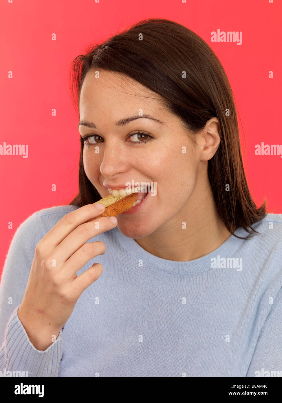 Young Woman Eating Garlic Bread Model Released Stock Photo - Alamy