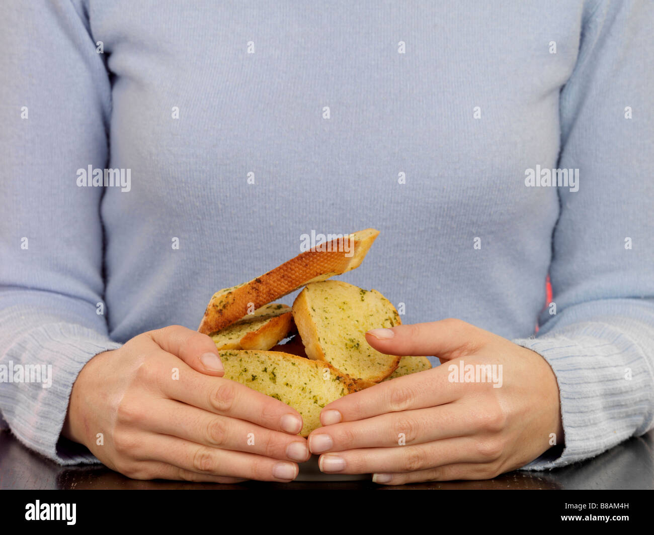Young Woman Eating Garlic Bread Model Released Stock Photo - Alamy