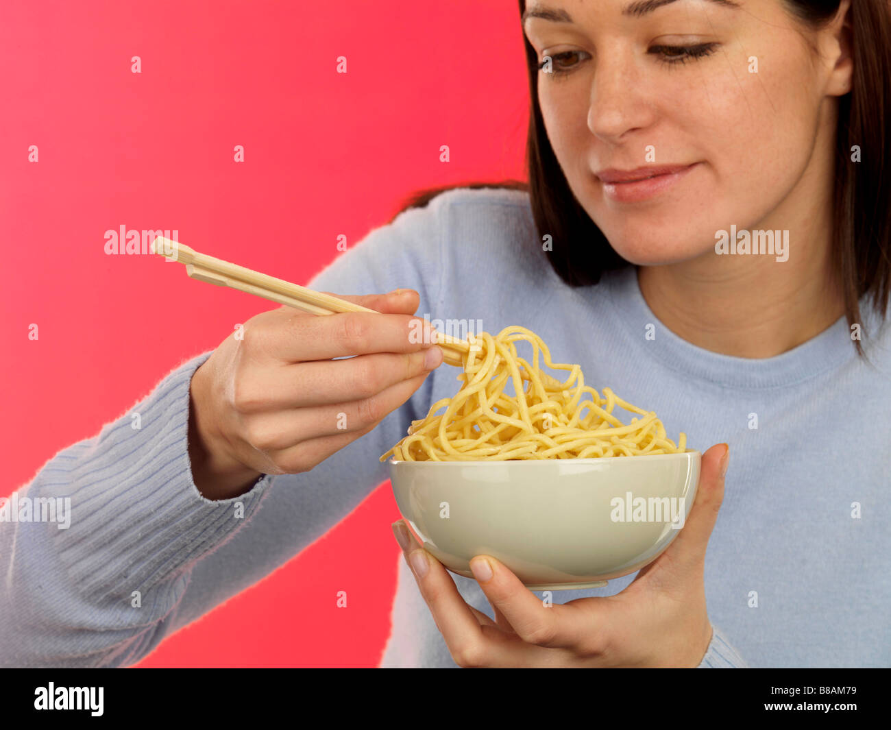 Young Woman Eating Noodles Model Released Stock Photo - Alamy
