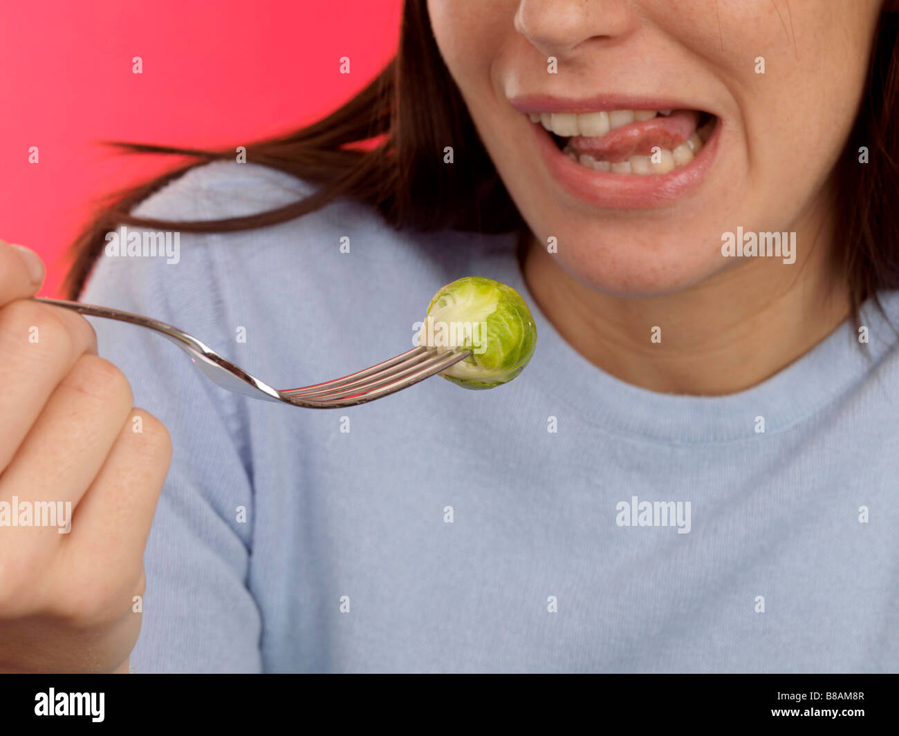 Young Woman Eating Brussel Sprouts Model Released Stock Photo - Alamy