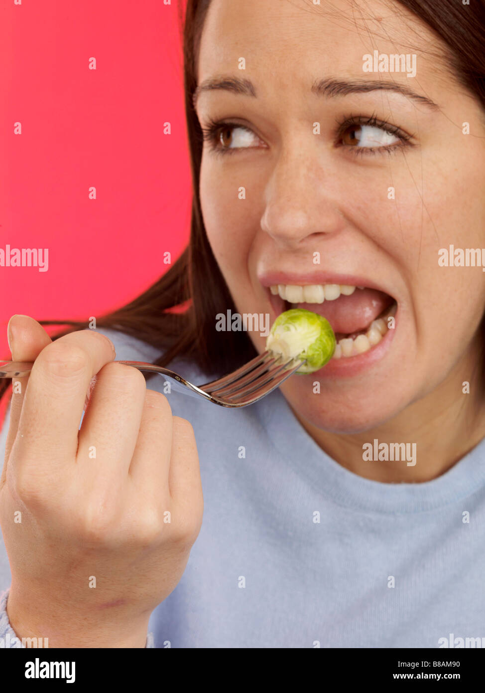 Young Woman Eating Brussel Sprouts Model Released Stock Photo - Alamy