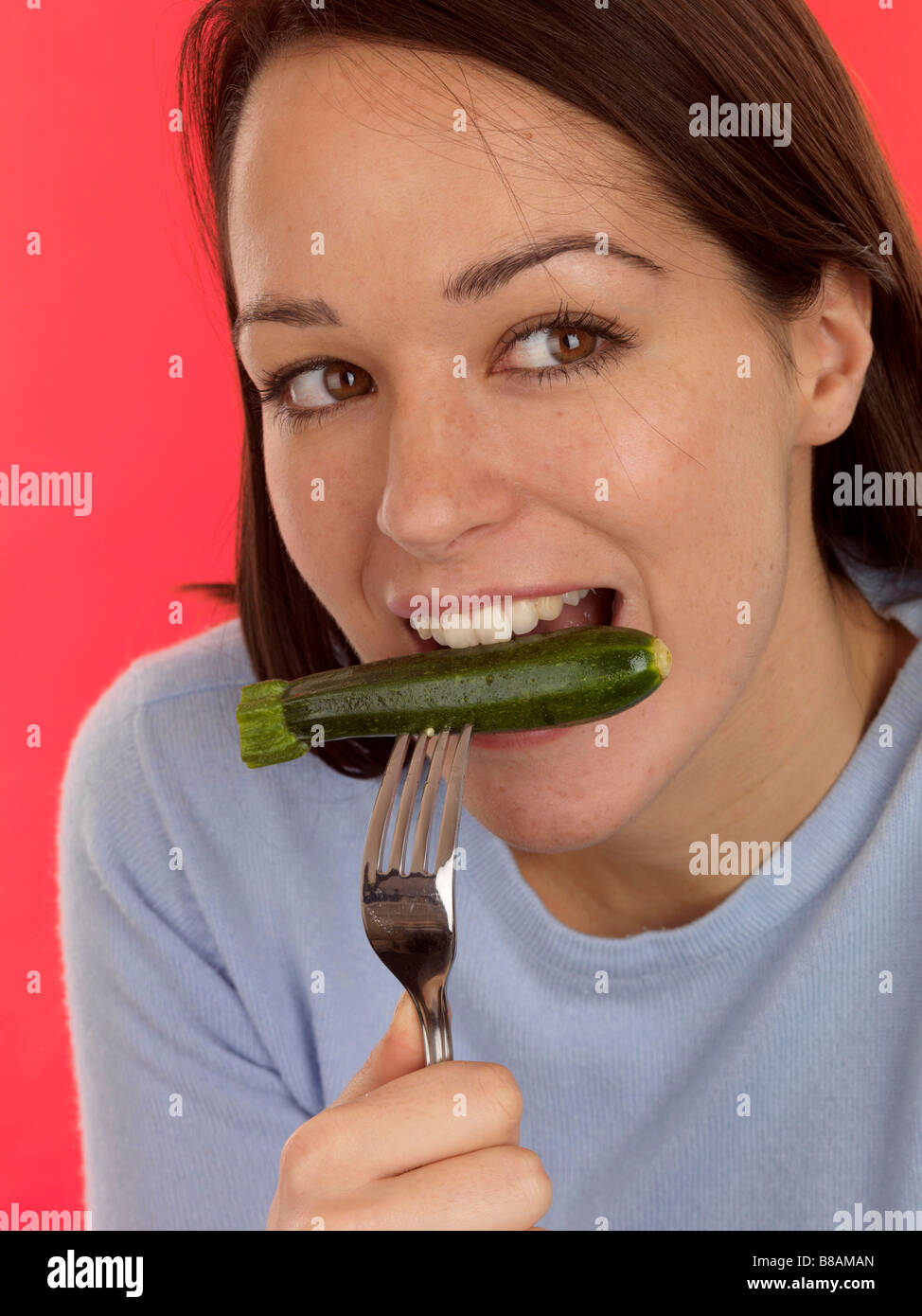 Young Woman Eating Baby Courgette Model Released Stock Photo - Alamy