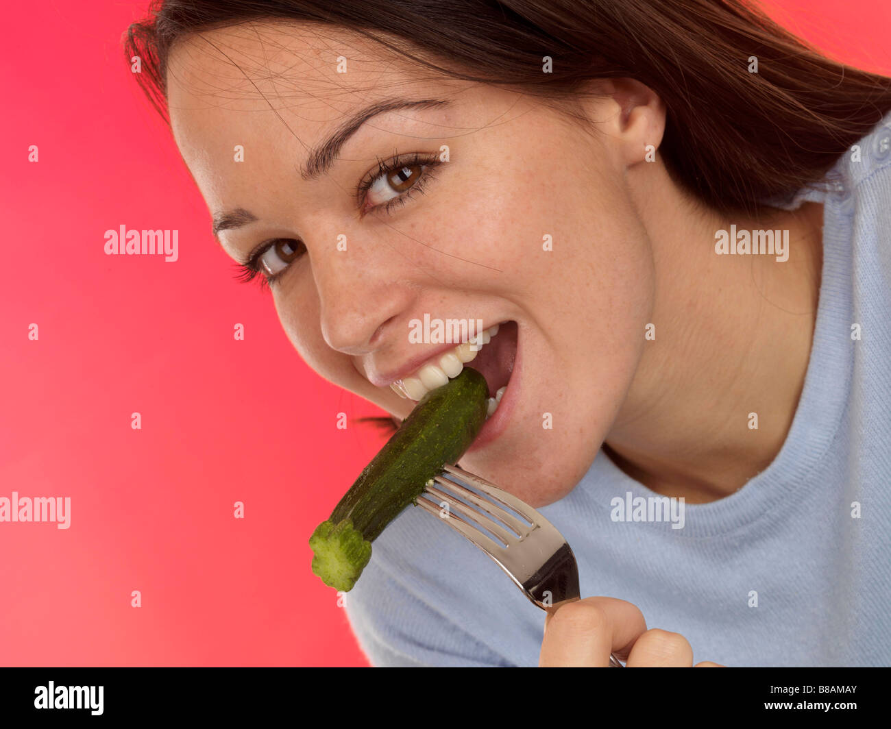 Young Woman Eating Baby Courgette Model Released Stock Photo - Alamy