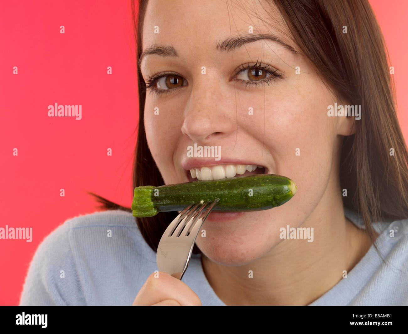 Young Woman Eating Baby Courgette Model Released Stock Photo - Alamy