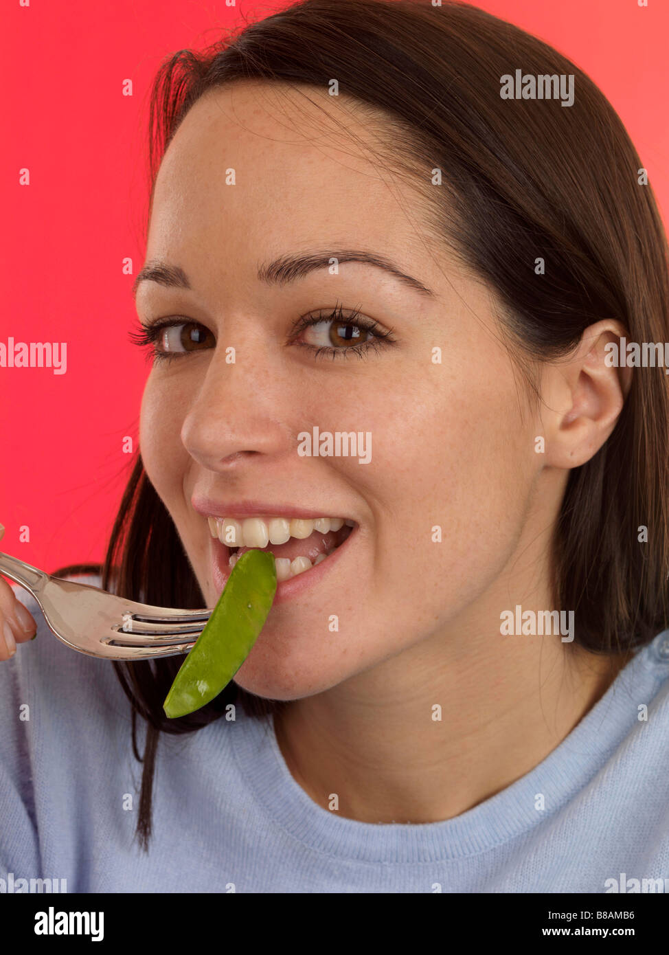 Young Woman Eating Sugar Snap Peas Model Released Stock Photo - Alamy