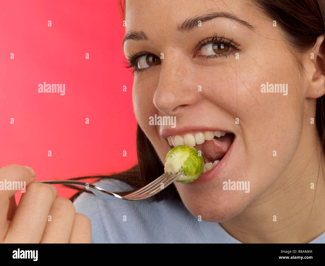 Young Woman Eating Brussel Sprouts Model Released Stock Photo - Alamy