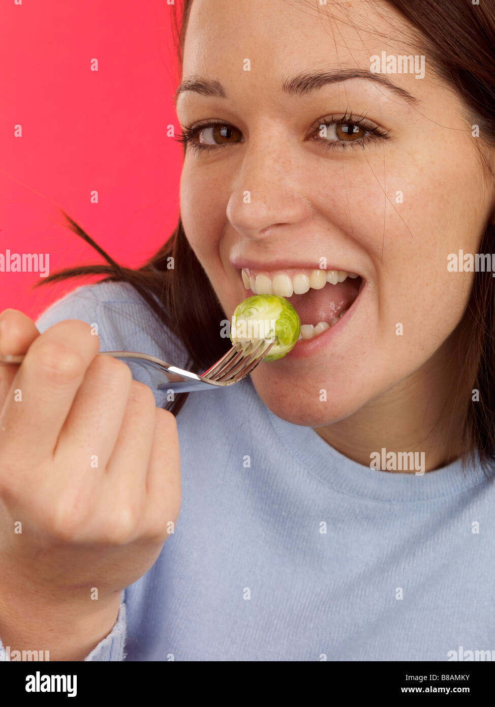 Young Woman Eating Brussel Sprouts Model Released Stock Photo - Alamy