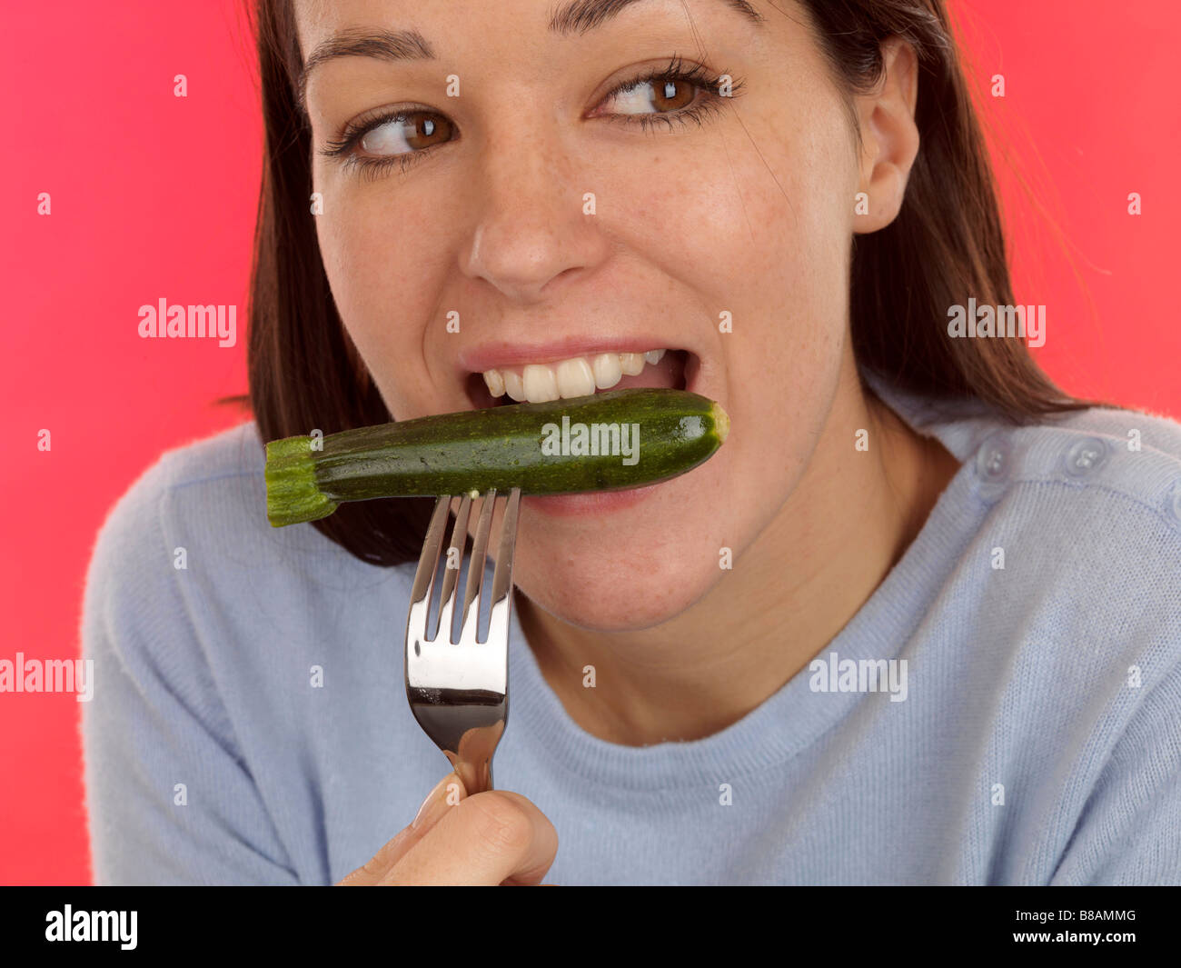 Young Woman Eating Baby Courgette Model Released Stock Photo - Alamy
