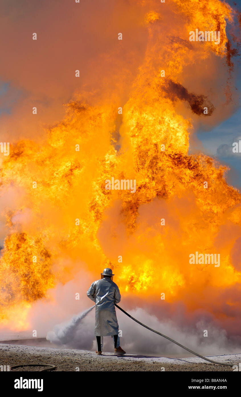 Fire Fighter Spraying Huge Fire Stock Photo - Alamy