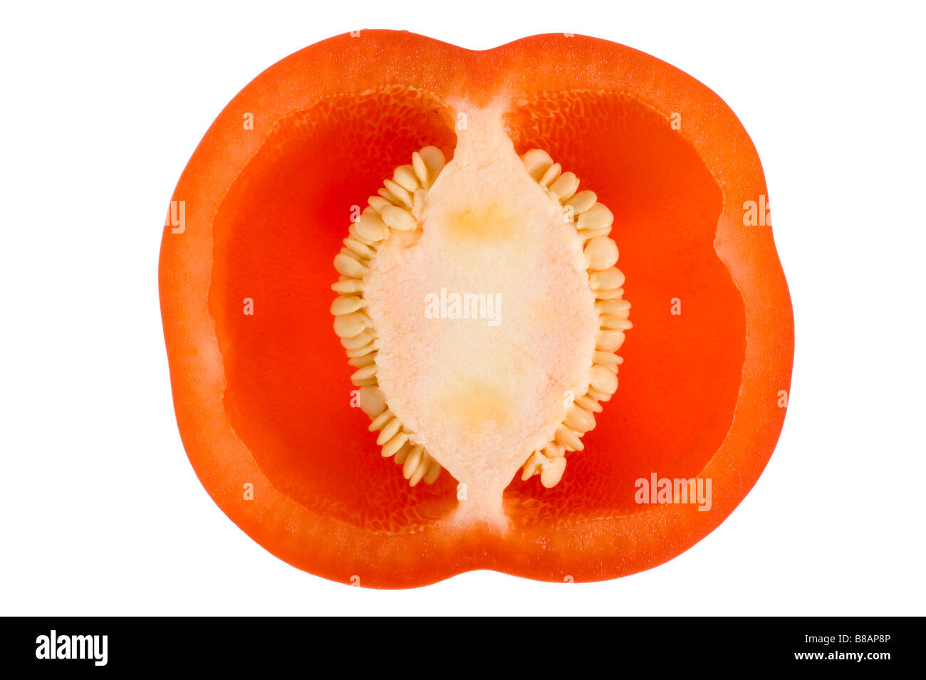 Cutout of a red pepper cut in half on its shortest side exposing the ...