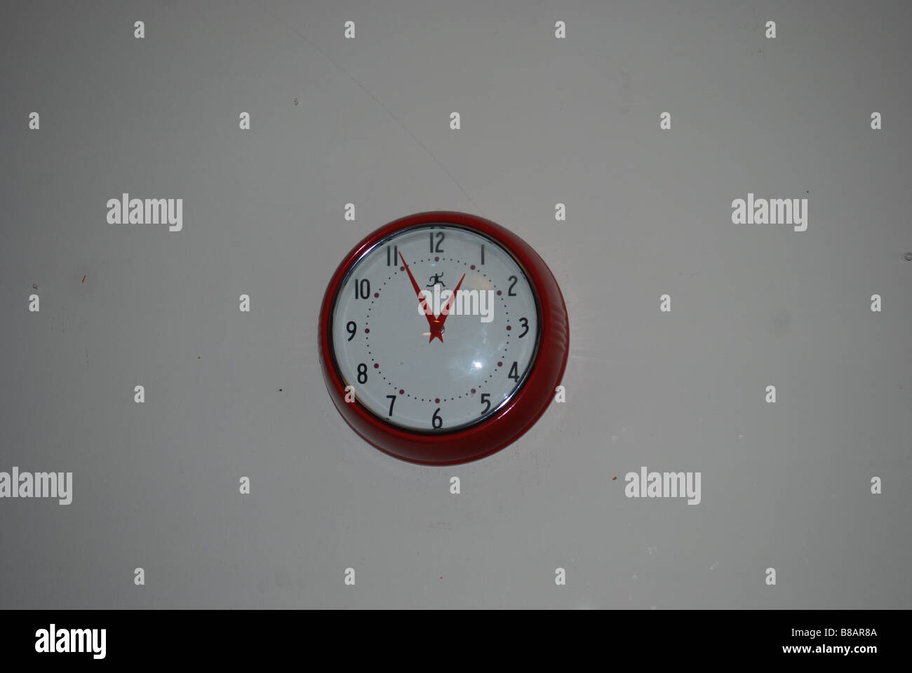 clock on wall red hands dial Stock Photo - Alamy