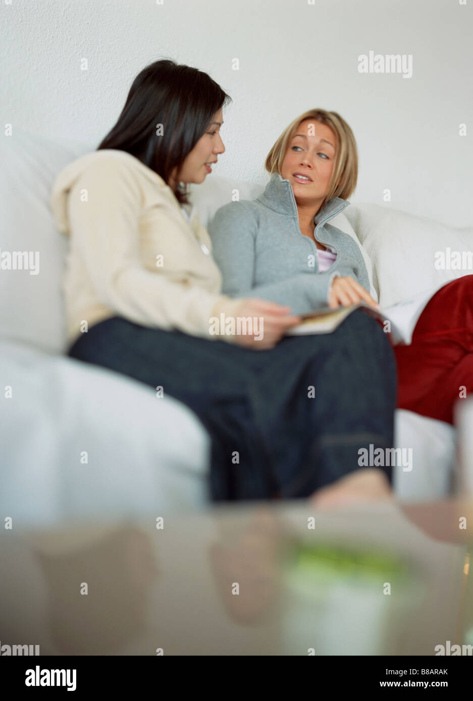 FV3384, zoomphotographics; Two Women Talking Couch Magazine Stock Photo ...