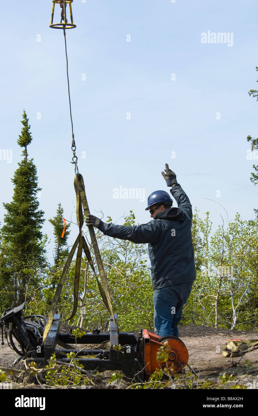 Ground Crew Preparing to Hoist Drill Rig by Helicopter, Mud Lake ...
