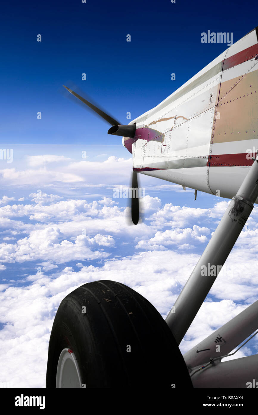 A small airplane in flight over clouds Stock Photo - Alamy