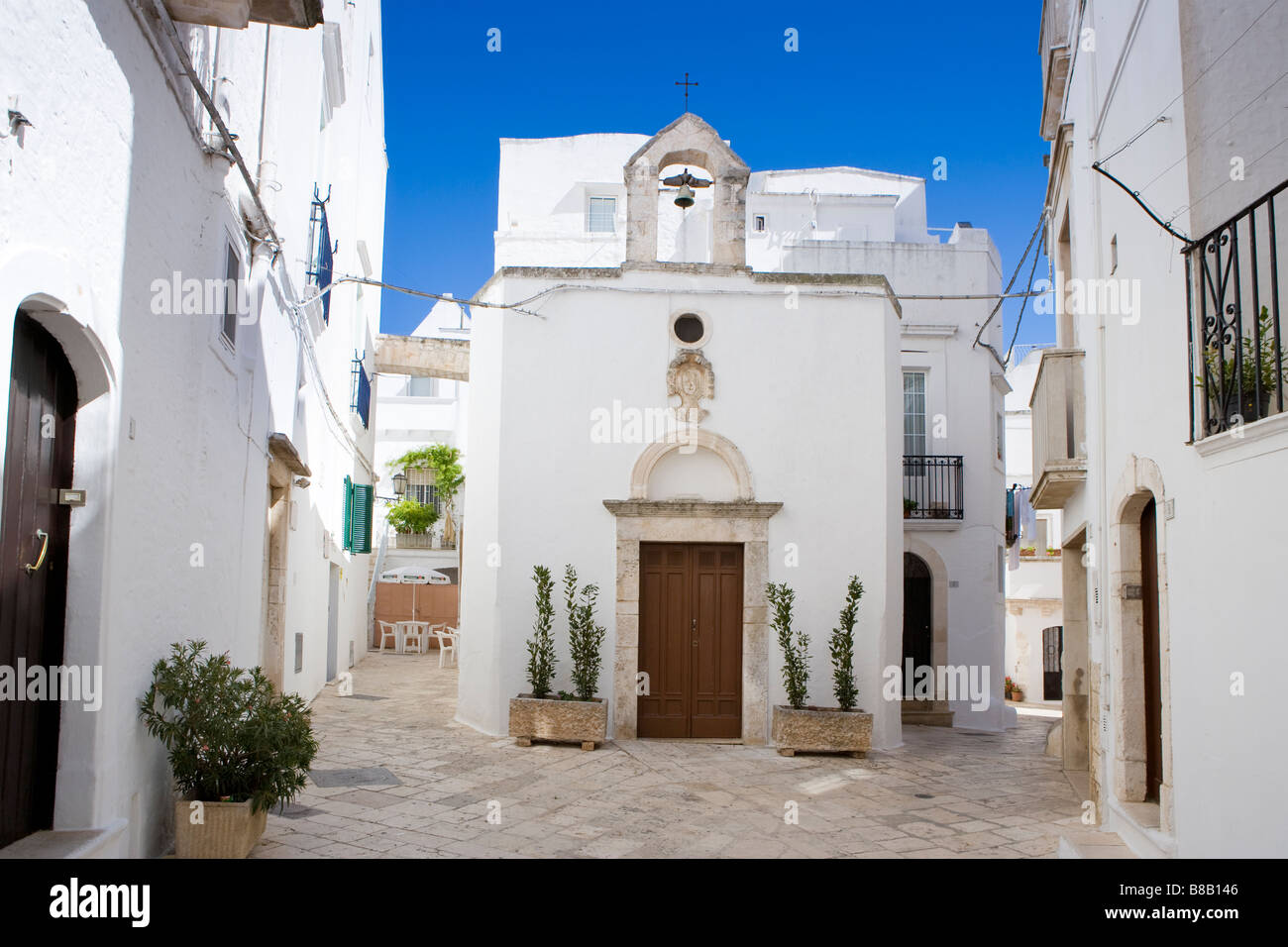 Chapel and white washed buildings Locorotondo Puglia Italy Stock Photo ...