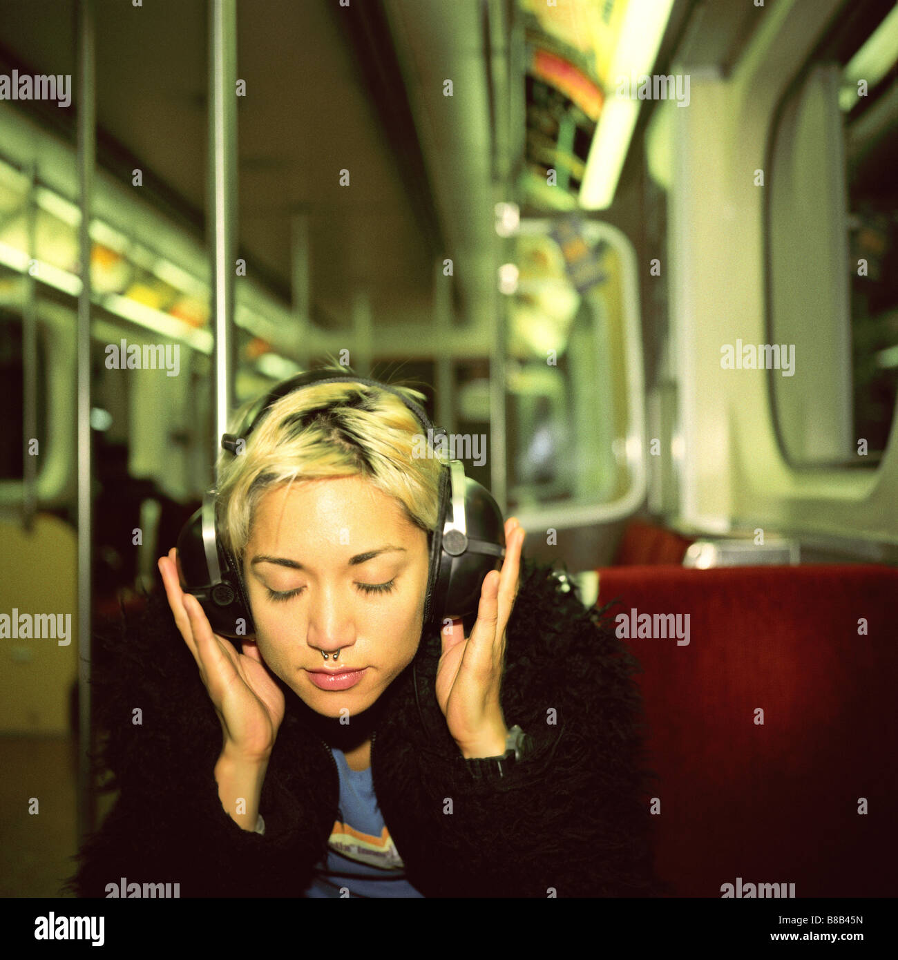 Woman subway eyes closed hi-res stock photography and images - Alamy