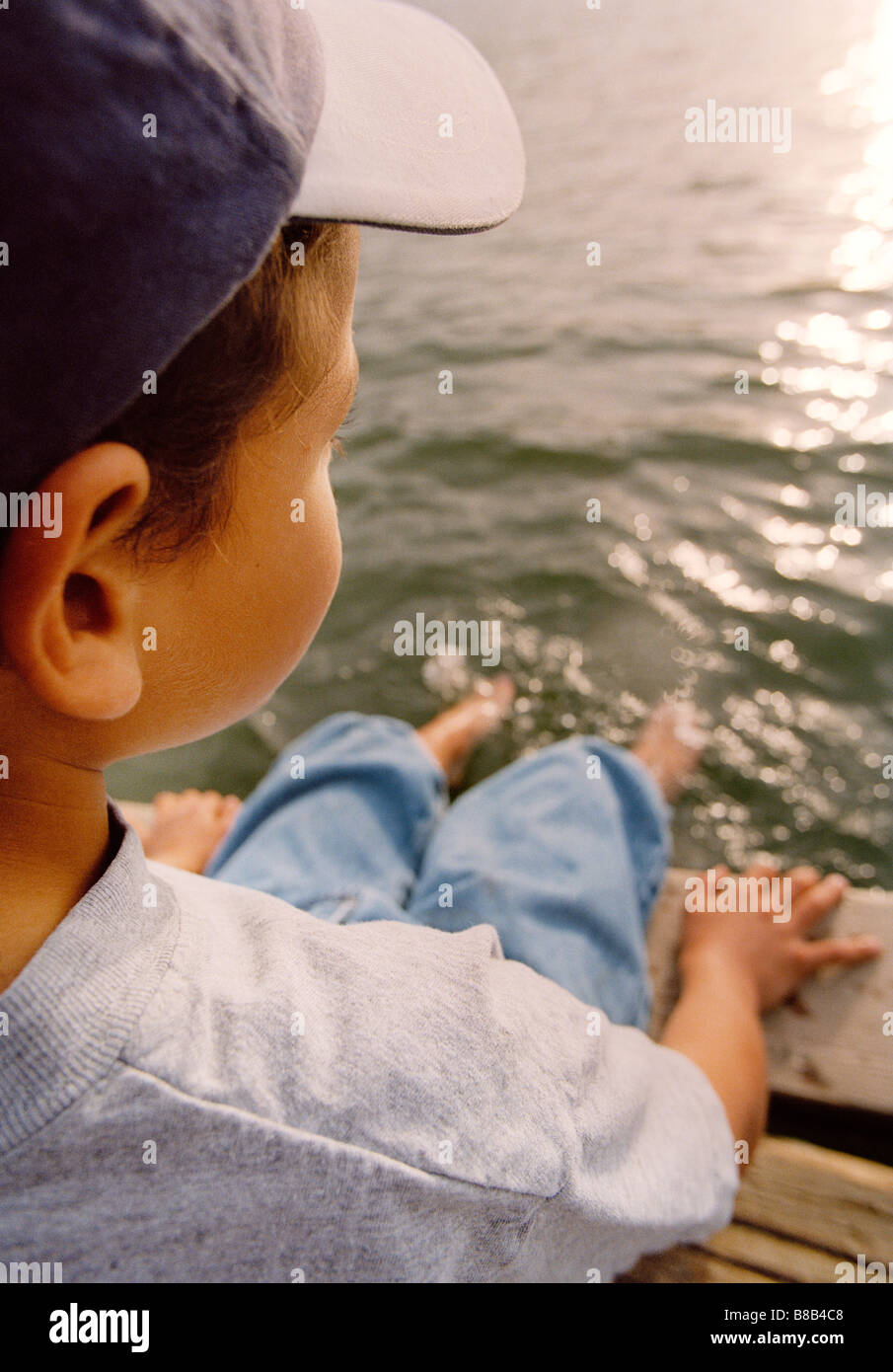 FV3729, Natural Moments Photography; Boy Sitting Dock Feet Water Stock ...