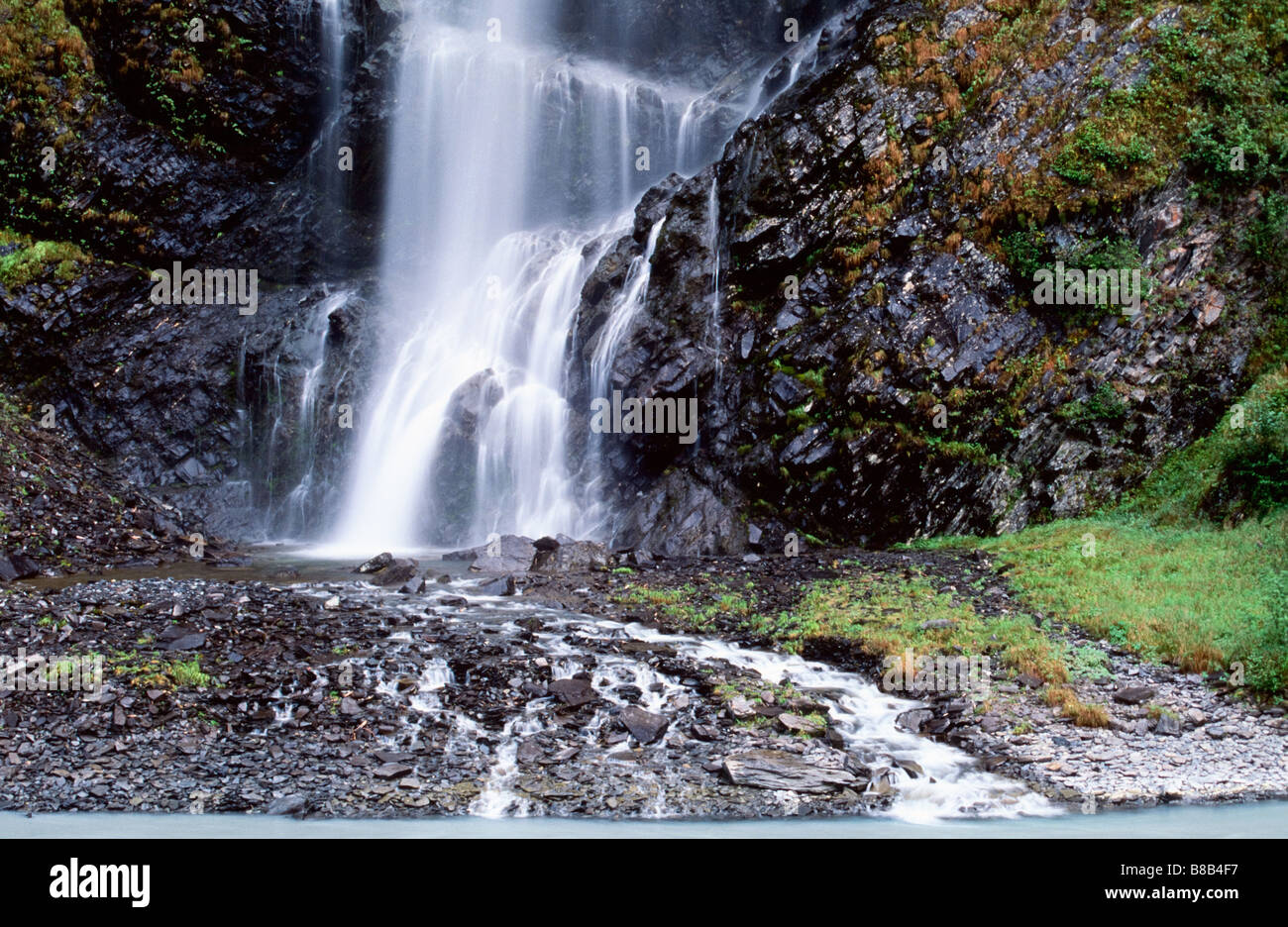 Waterfall flowing from the mountain Stock Photo - Alamy