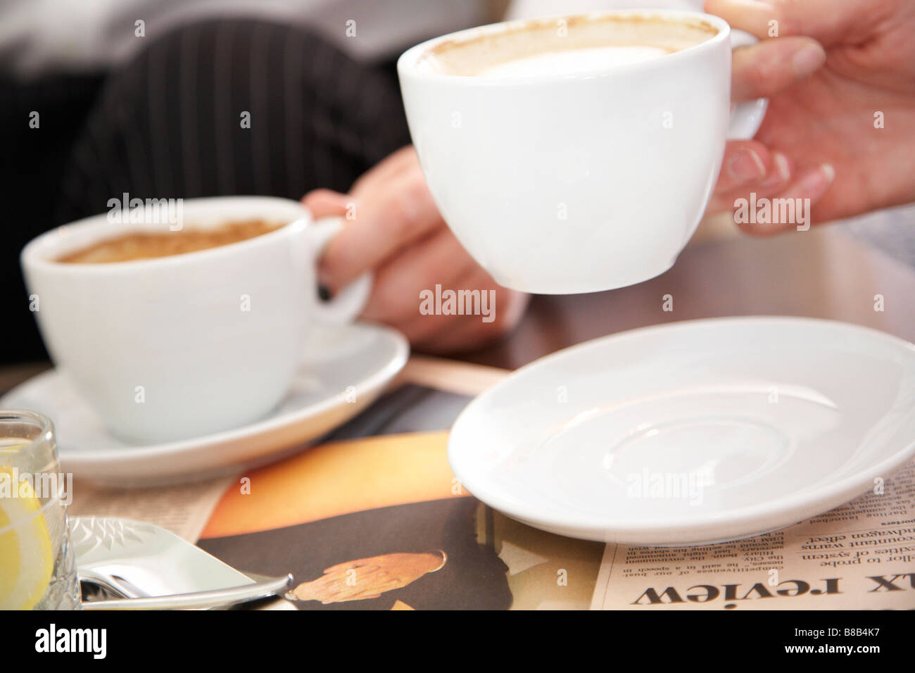 Two people sat drinking coffee Stock Photo - Alamy