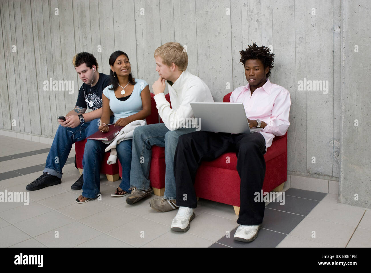 Group sitting on sofa Stock Photo - Alamy