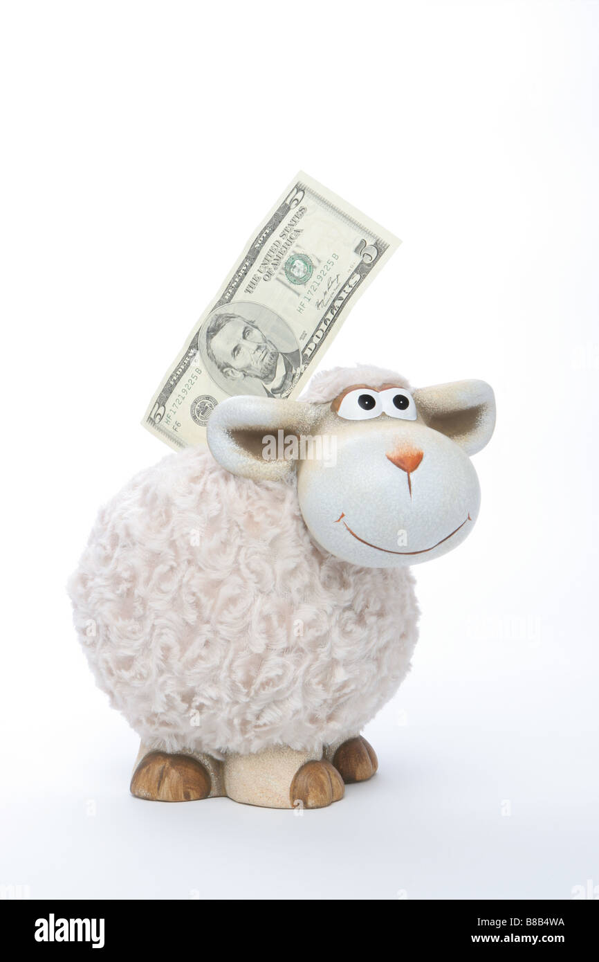 Sheep coin bank with american dollars Stock Photo - Alamy