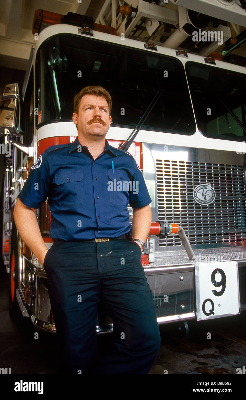 Firefighter Leaning Fire Truck, Vancouver, British Columbia, NMR Stock ...