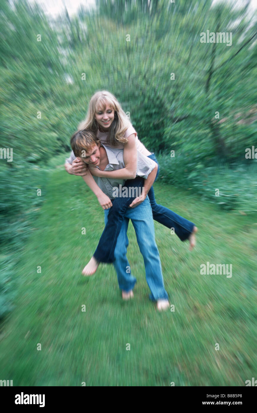 FV3838, Trevor Bonderud; Couple Piggyback Grass Stock Photo - Alamy