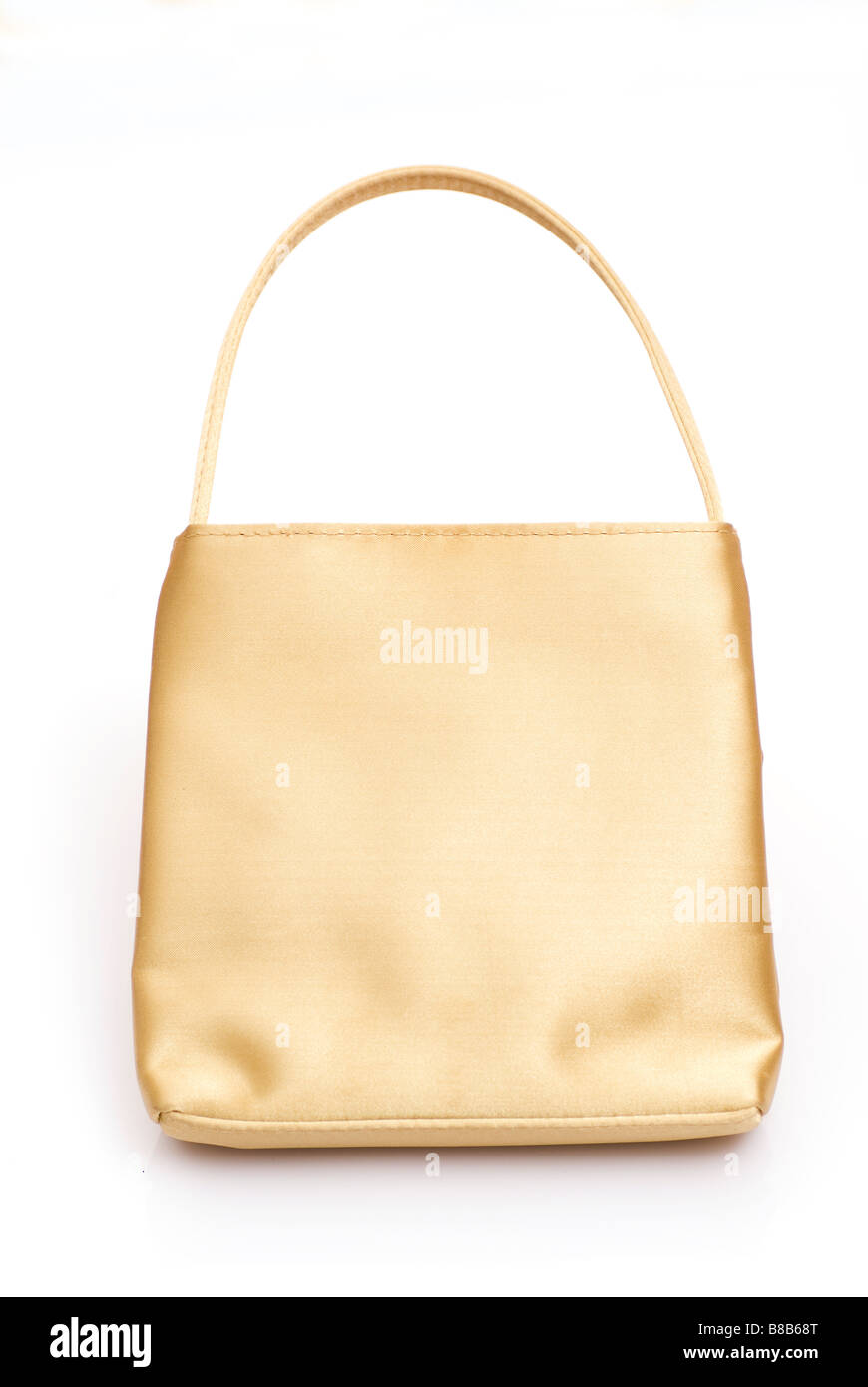 Golden woman's handbag on a white background Stock Photo - Alamy