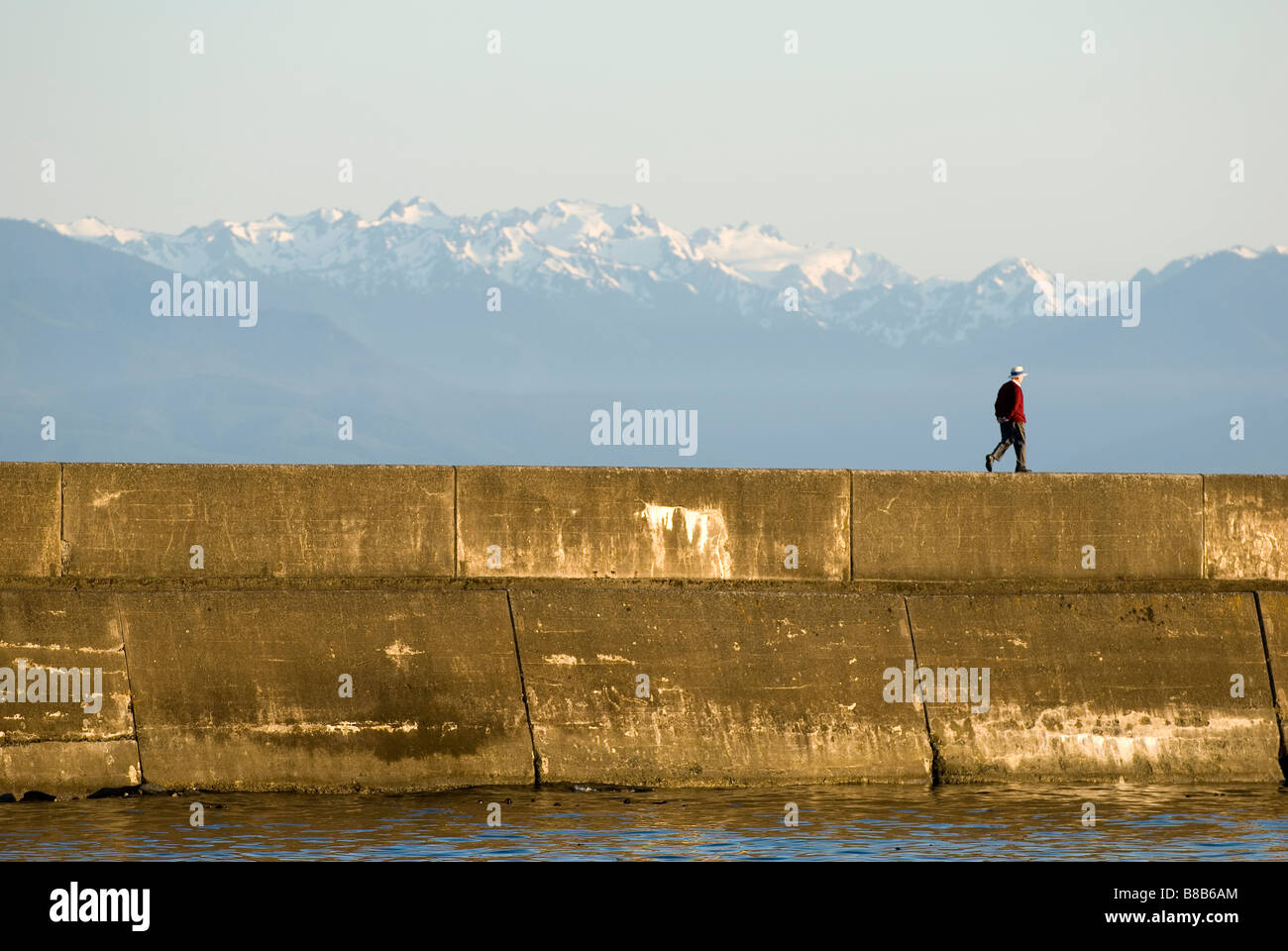 Man walking along Breakwater, Victoria, BC Stock Photo - Alamy