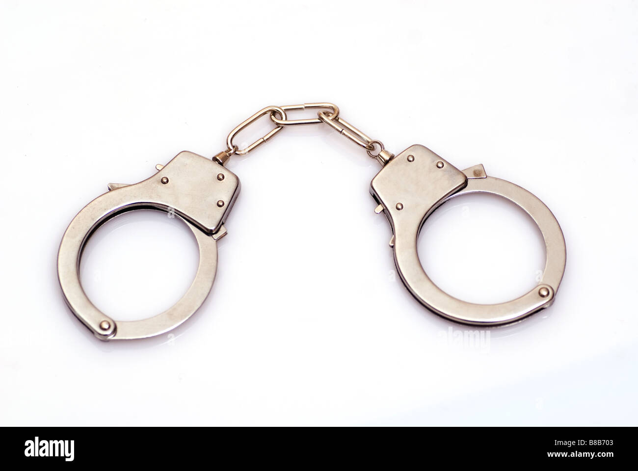 Metal handcuff isolated on a white background Stock Photo - Alamy