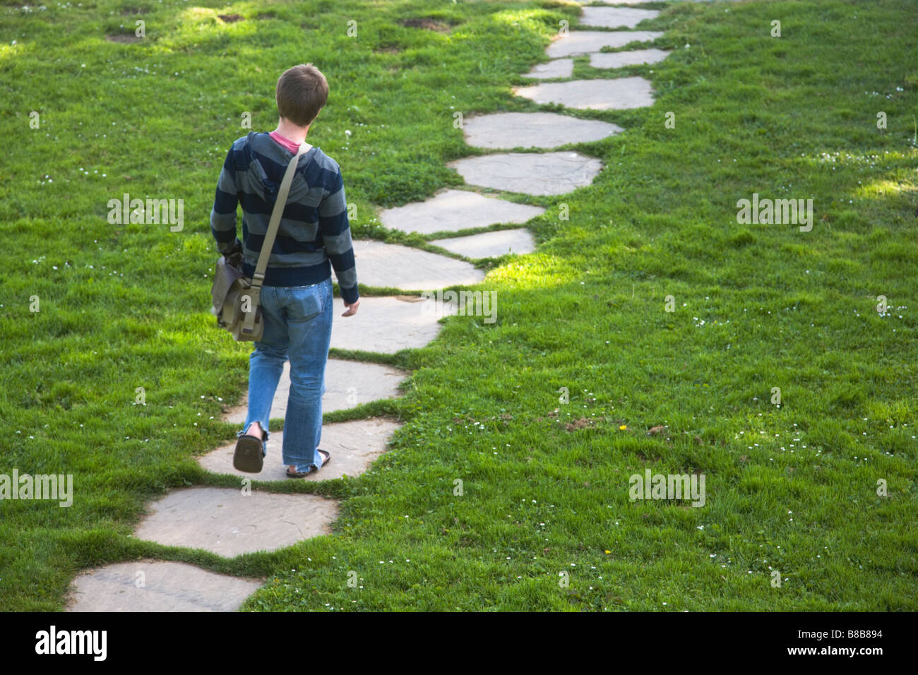 Man walking on stepping stone path on grass lawn, Sutro Heights Park ...