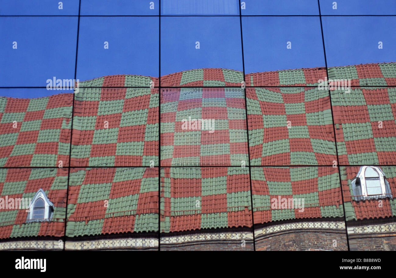 St Mary Magdalene church roof reflection in a modern glass building ...