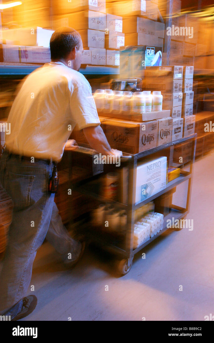 Man Warehouse Pushing Cart Stock Photo - Alamy
