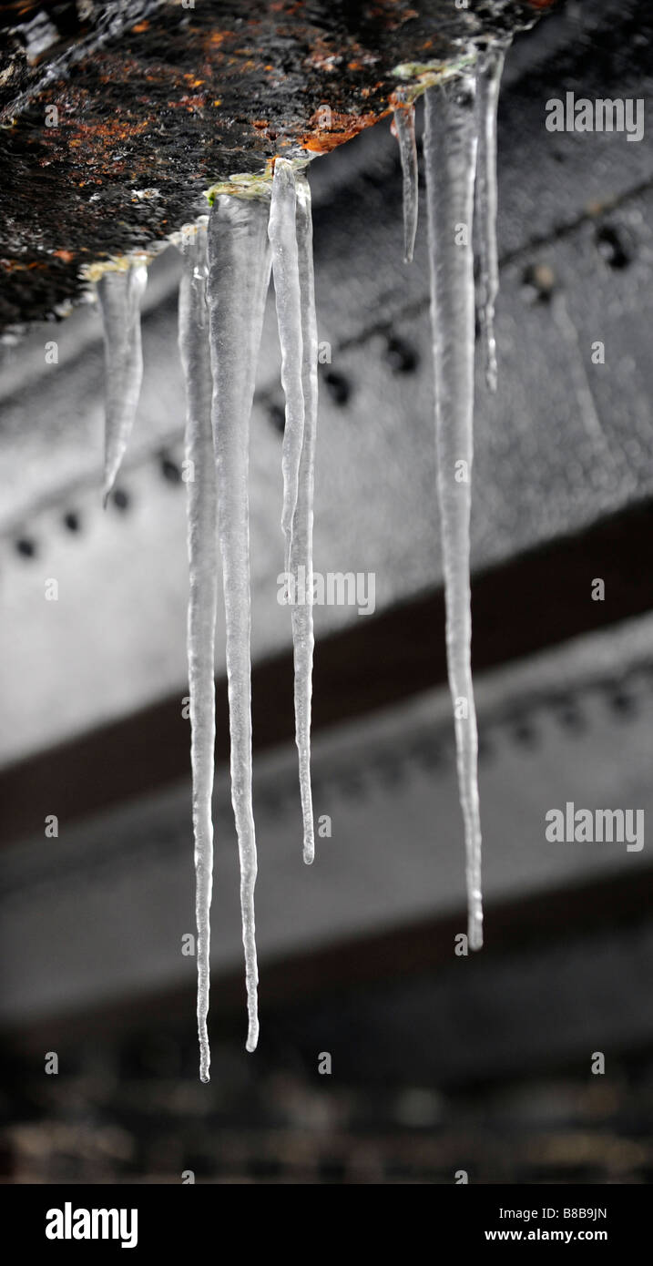 Icicles' hanging from a underneath of a metal road bridge during a cold ...