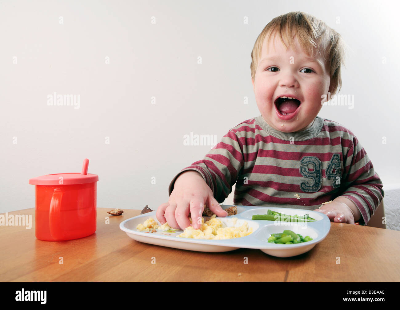 Baby boy eating at table (with signed model release - available for ...