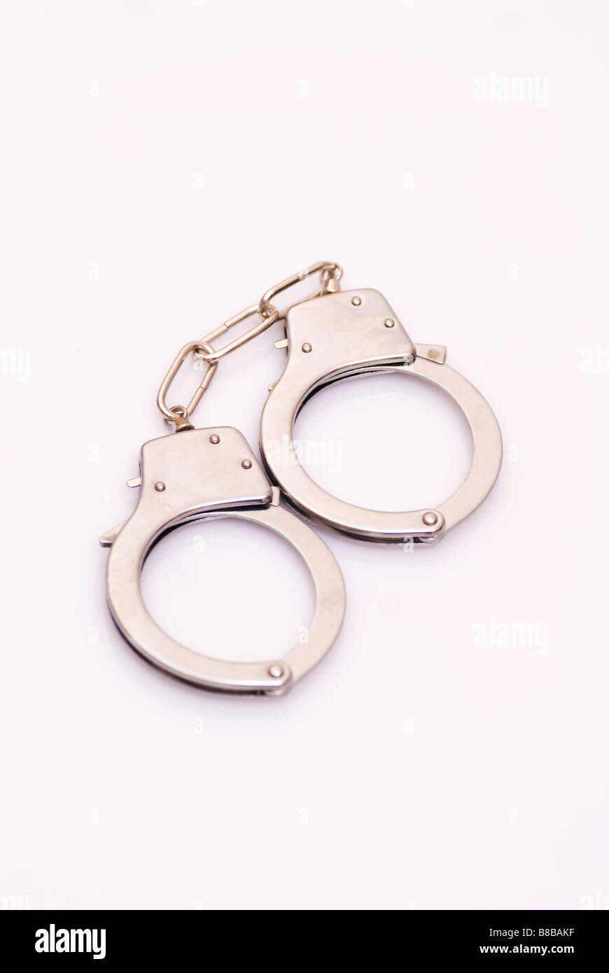 Metal handcuff isolated on a white background Stock Photo - Alamy