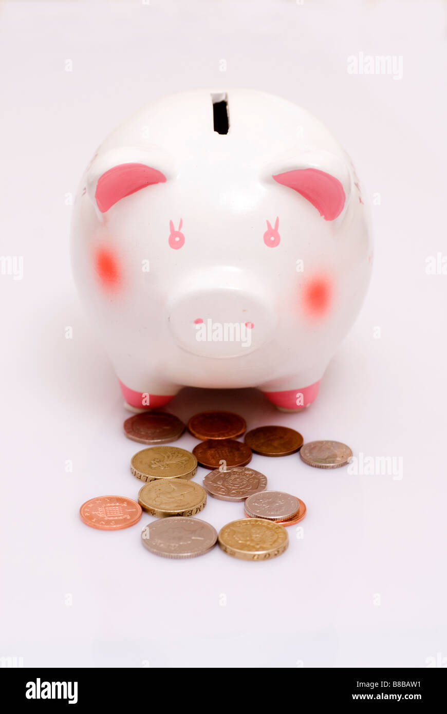 British coins out of a piggy bank on a white background Stock Photo - Alamy