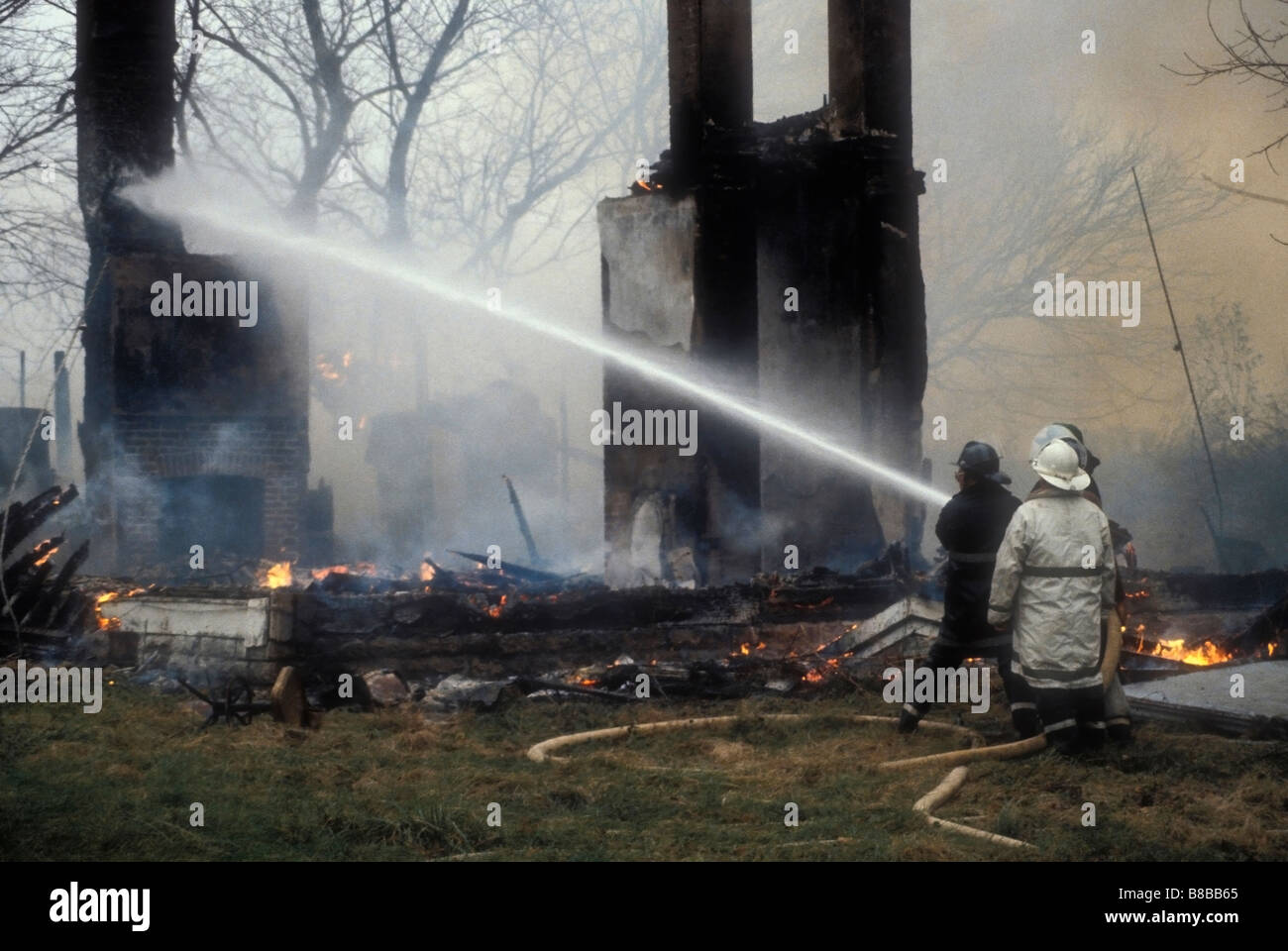 Firemen Battling A House Fire Stock Photo - Alamy